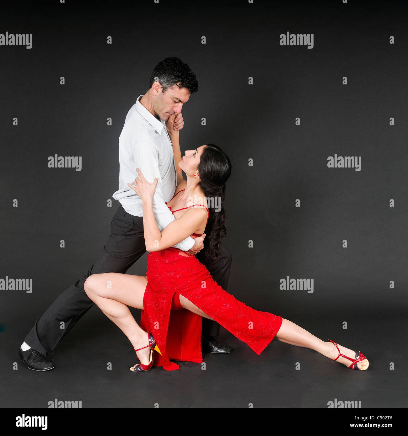 Couple dances tango On black Background Stock Photo - Alamy