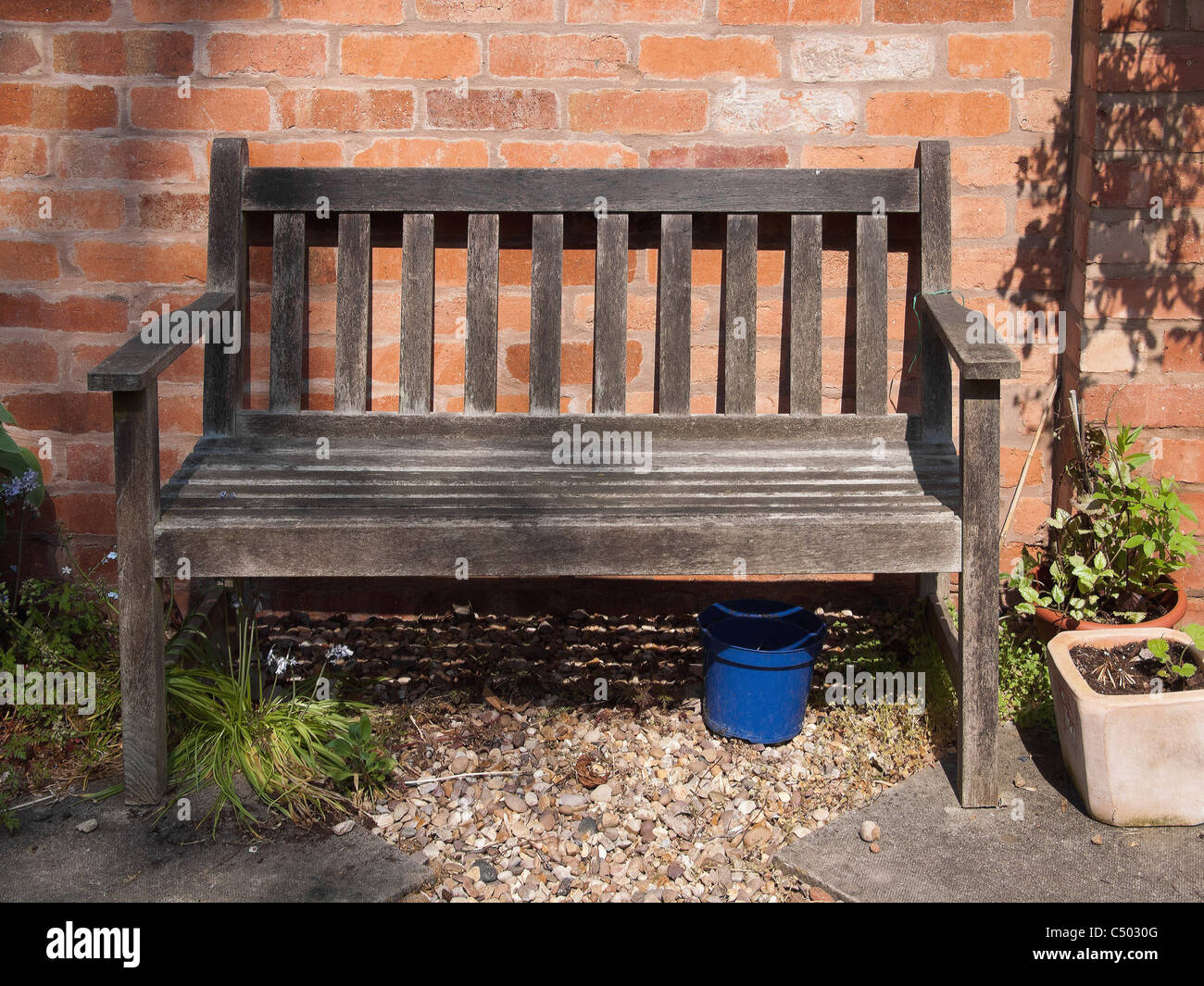 a bench in a country garden Stock Photo - Alamy