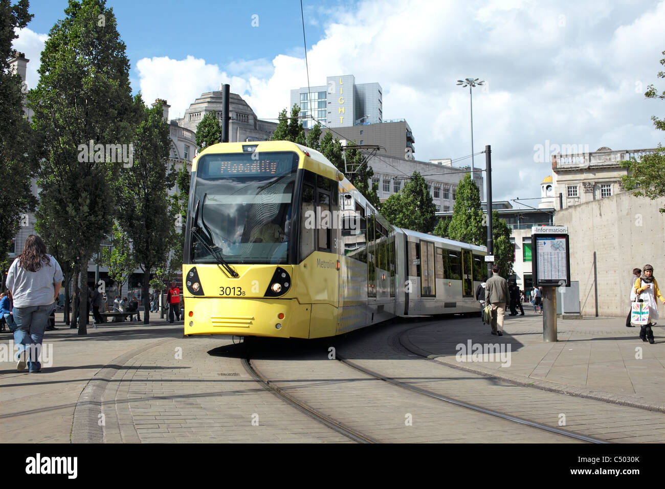 A tram passing Piccadilly Gardens in the centre of Manchester Stock ...
