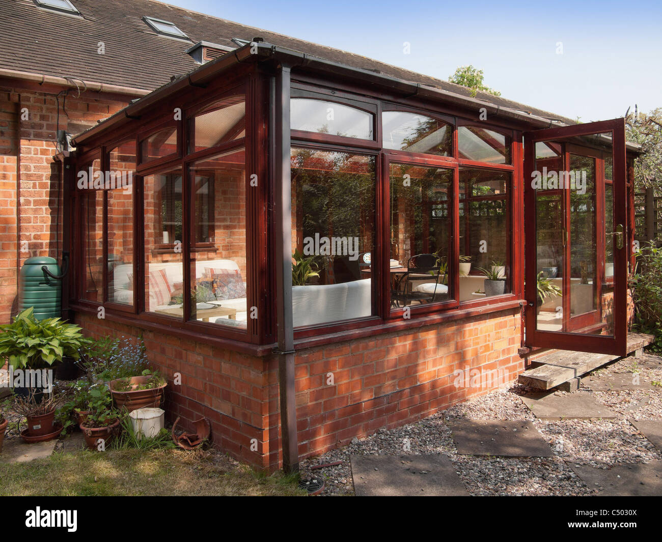 conservatory tables chairs plants room in house next to garden Stock ...