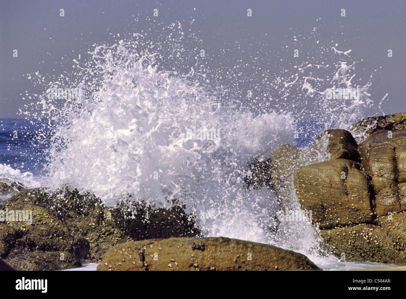 Sea spray over Rocks Stock Photo - Alamy