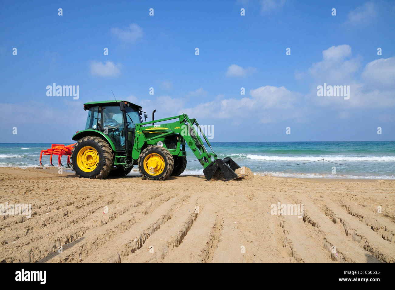 Tractor cleans the beach. Photographed in Haifa, Israel Stock Photo - Alamy