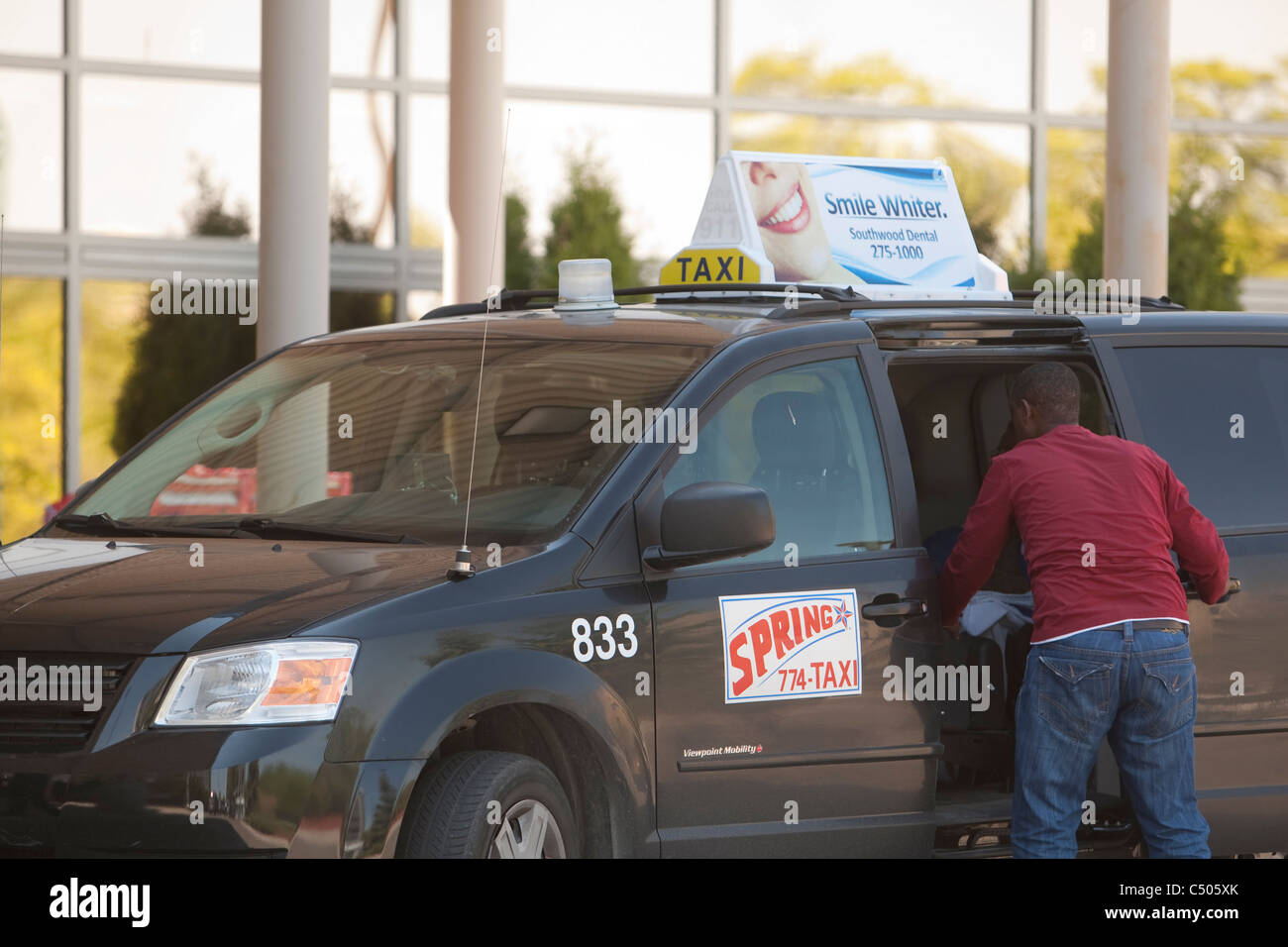 A Spring Taxi cab driver is seen by his car in Winnipeg Thursday May 26 ...