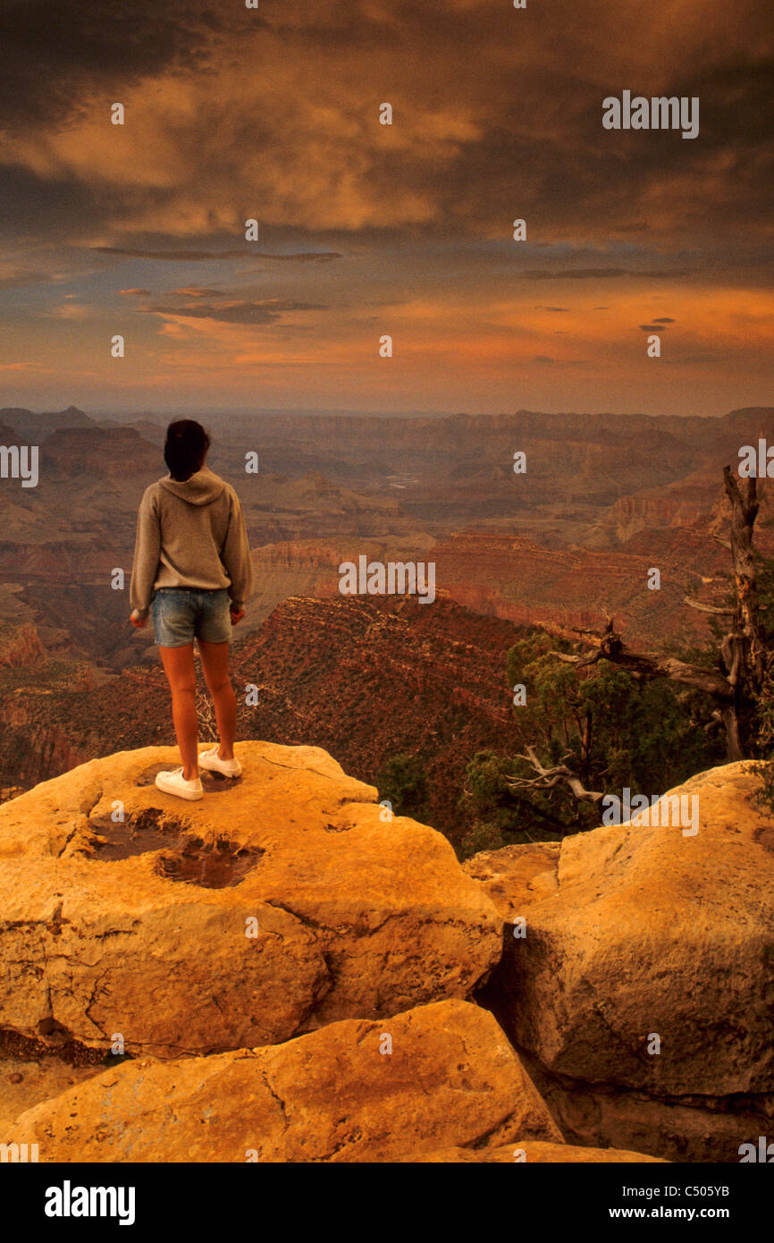 Tourist views sunset at Grand Canyon, from Grandview Point, South Rim ...