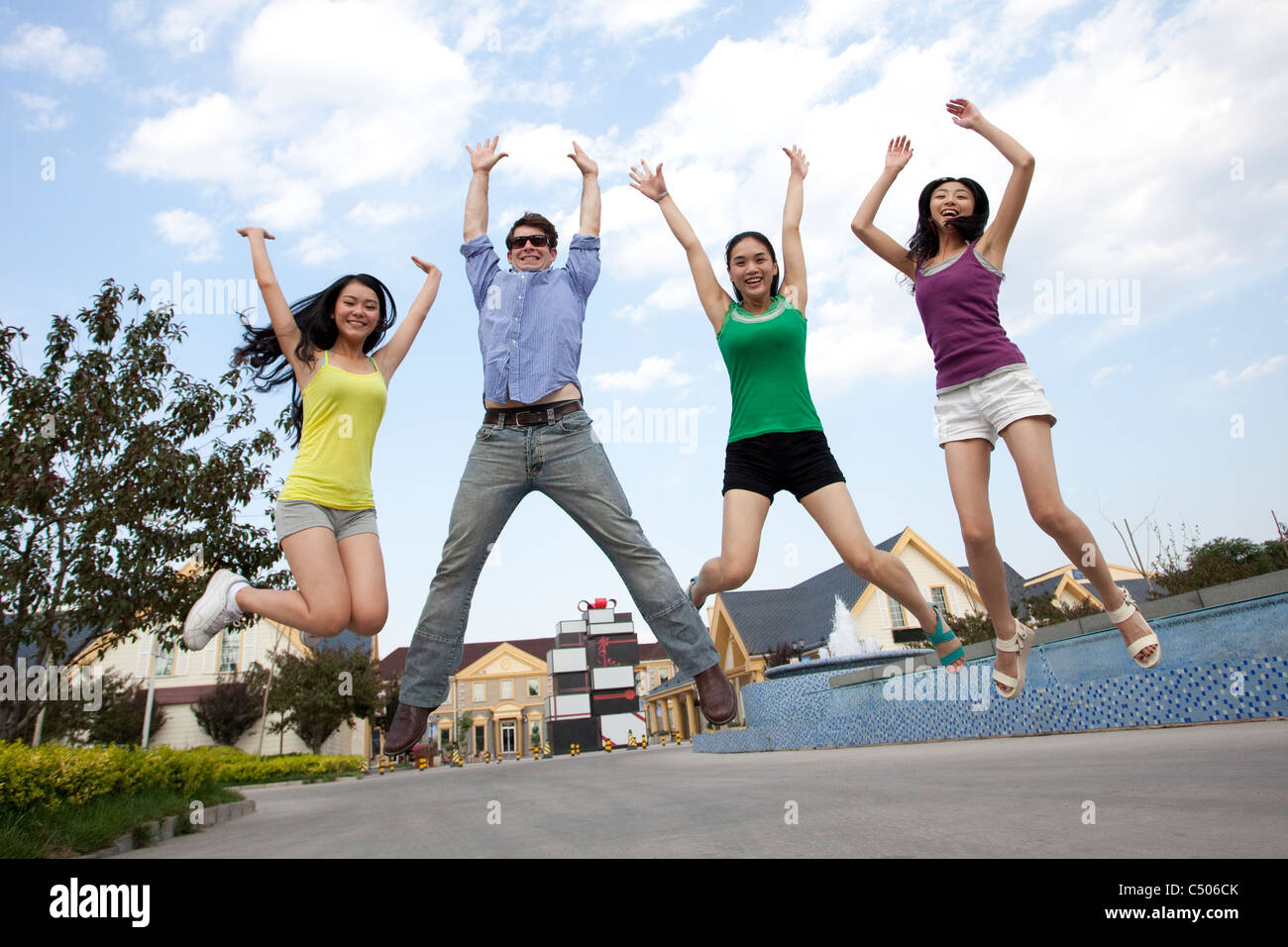 Excited Friends Jumping Stock Photo - Alamy