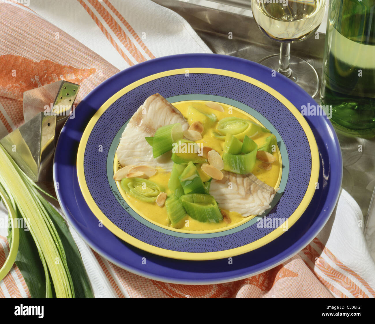 Leek with curry - sauce and gillet of fish Stock Photo - Alamy