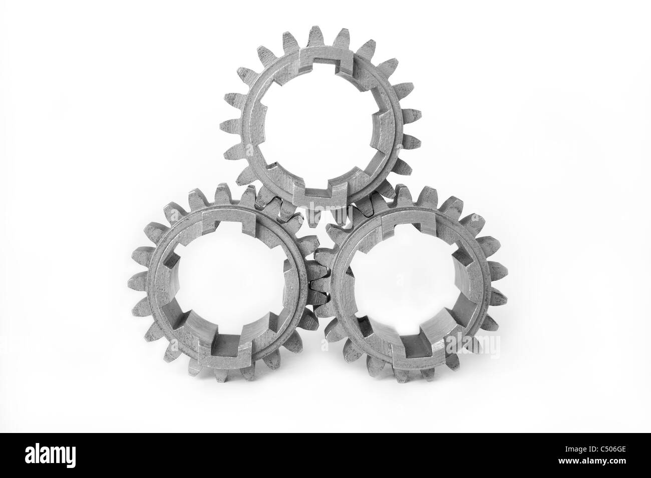 It depicts three gears on white background Stock Photo - Alamy