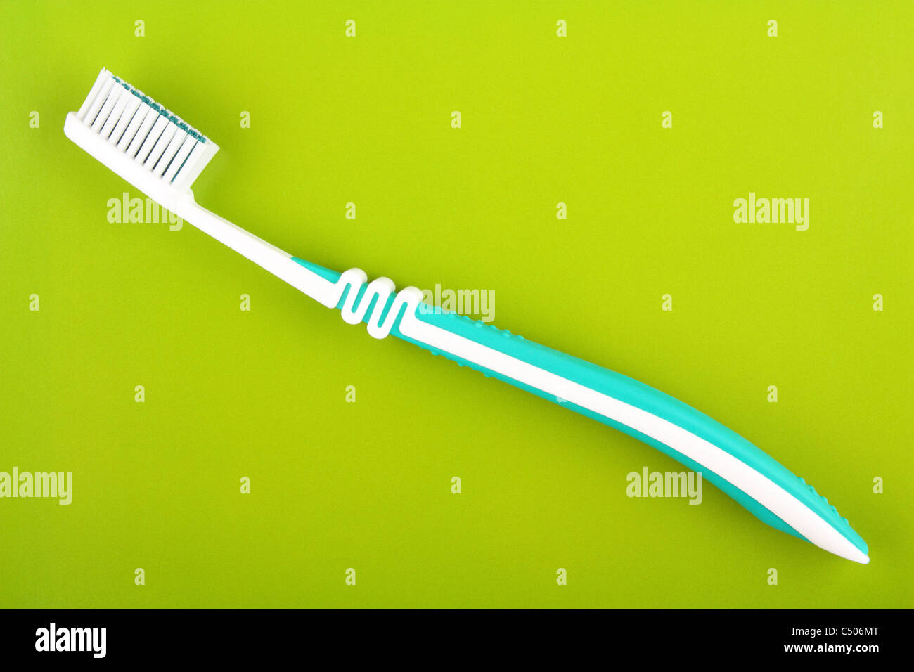 White-green tooth-brush on a green background Stock Photo - Alamy