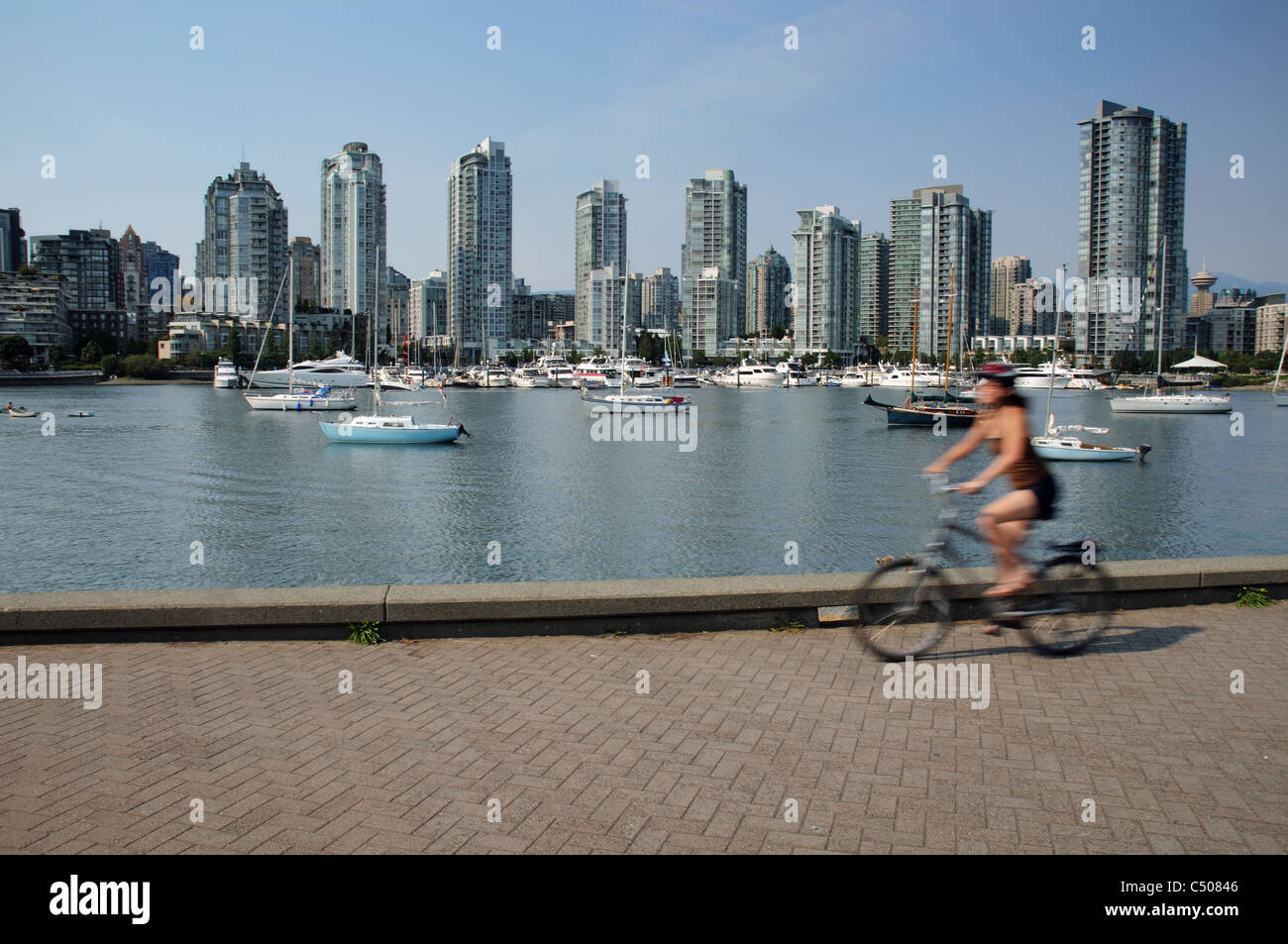 A woman cycling along the Sea Wall cycleway in Vancouver, Canada Stock ...