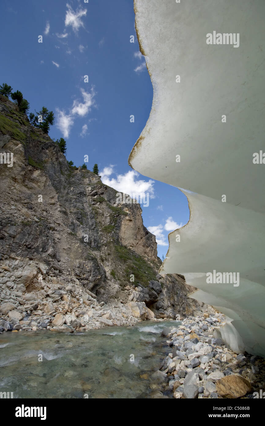 Fantastic wavy ice shape (glacier) near river in East Sayan mountains ...