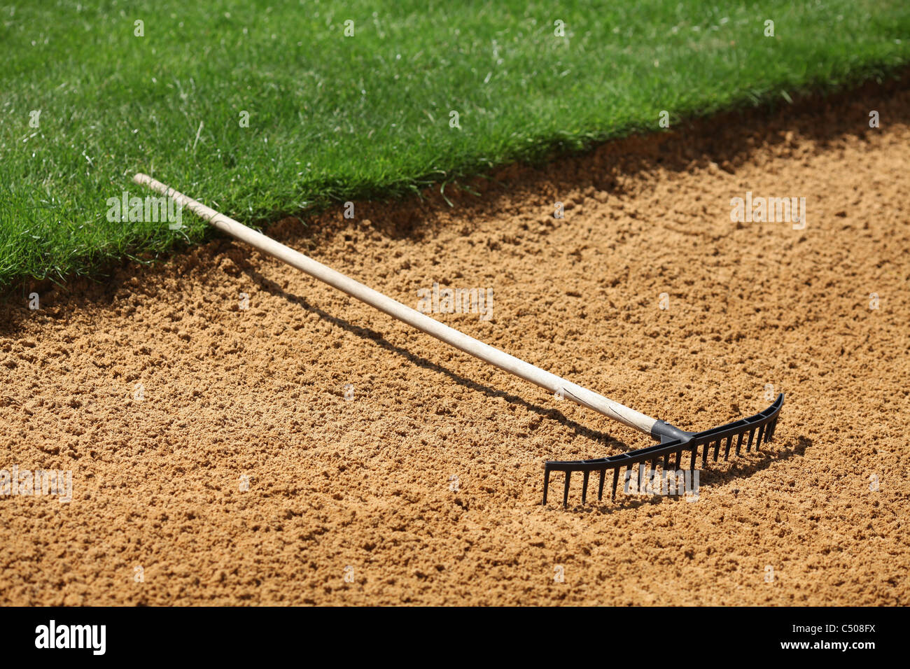 A rake in a bunker. Picture by James Boardman Stock Photo - Alamy