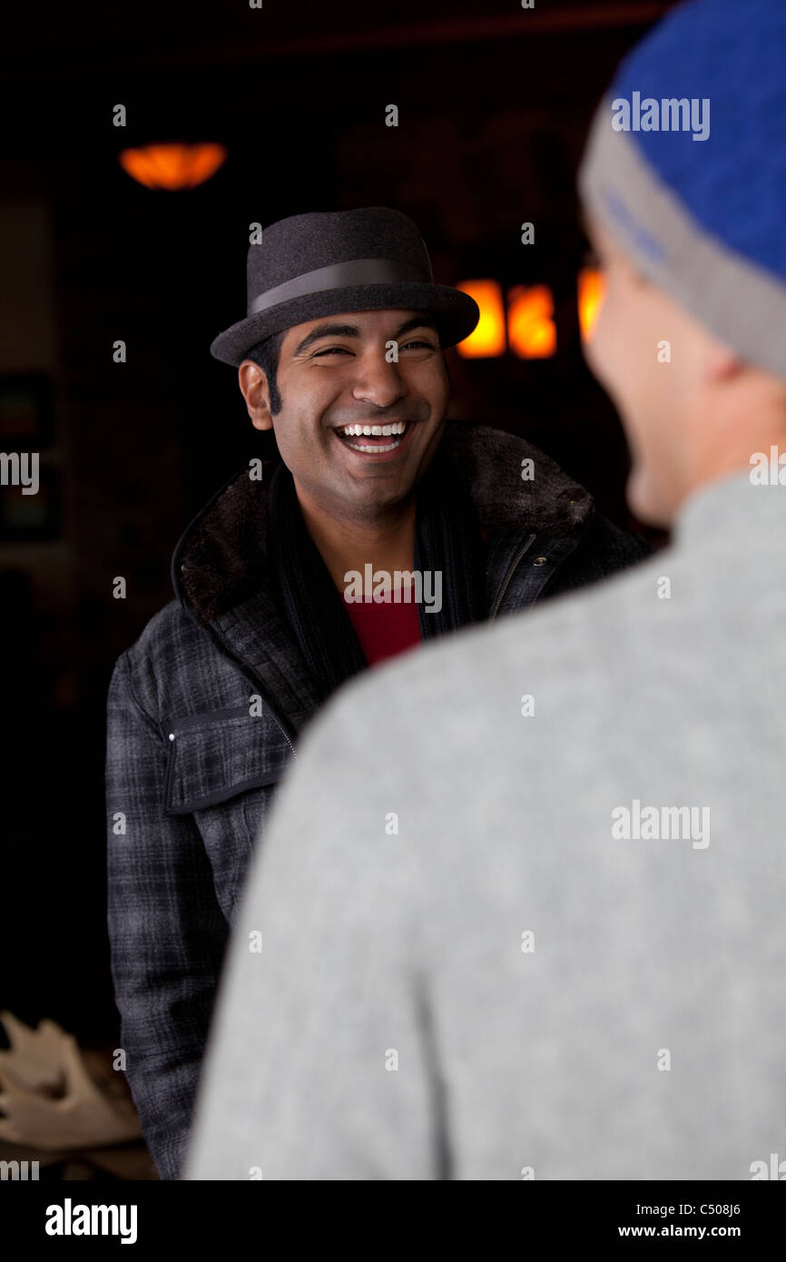 Smiling man socializing with friend Stock Photo - Alamy