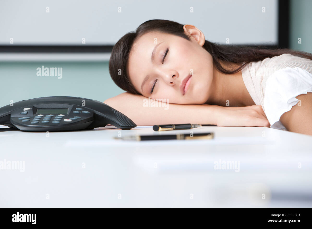 Young Businesswoman Napping in Meeting Room Stock Photo - Alamy