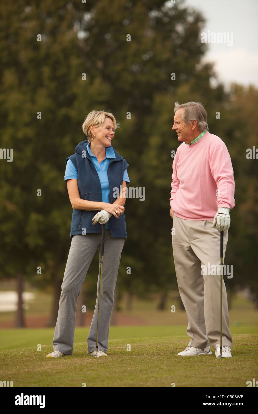 Caucasian couple standing on golf course Stock Photo - Alamy