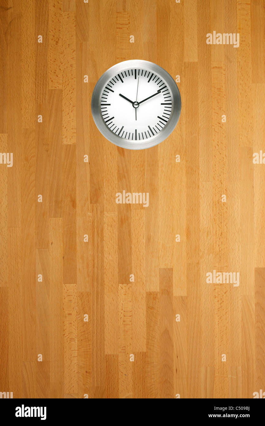 A wall clock in a work place scene Stock Photo - Alamy