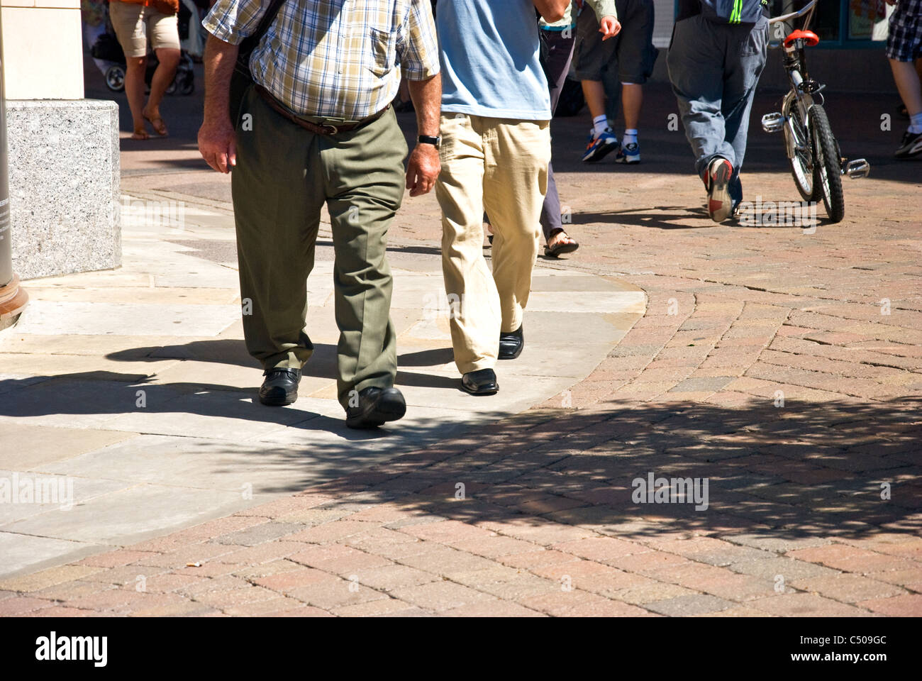People walking through a town Stock Photo - Alamy
