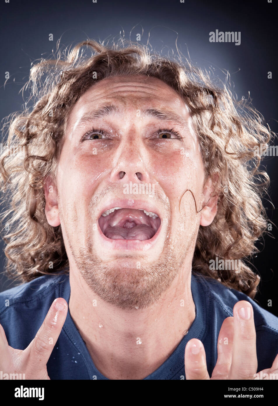 Caucasian man looking up and shouting Stock Photo - Alamy