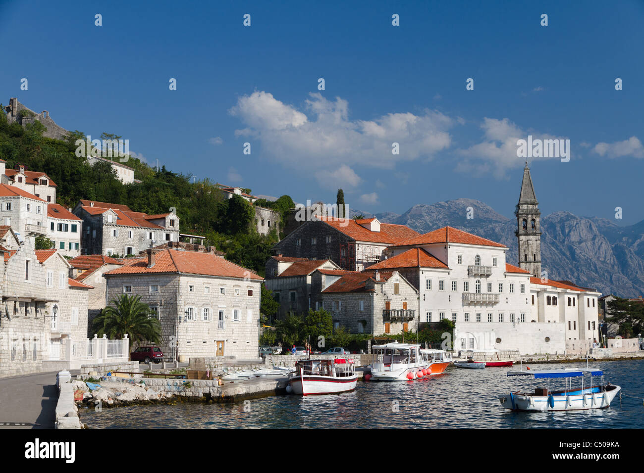 Quiet historic town of Perast with white houses, boats on the slopes of ...