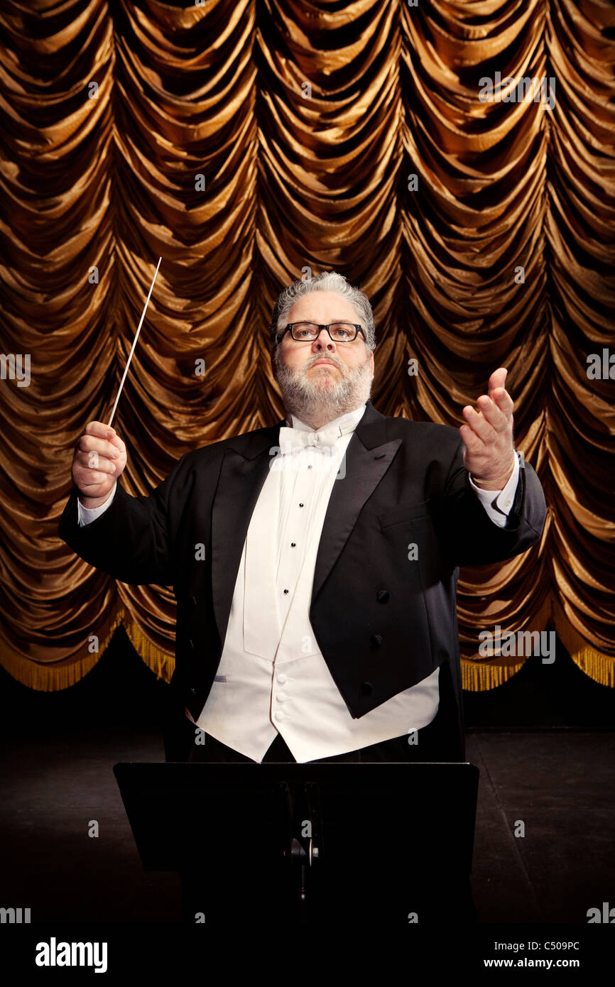 Caucasian conductor at podium Stock Photo - Alamy