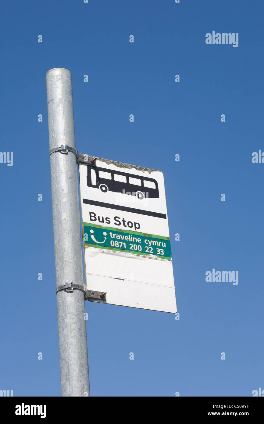 Bus stop sign on metal post showing services by traveline cymru in ...