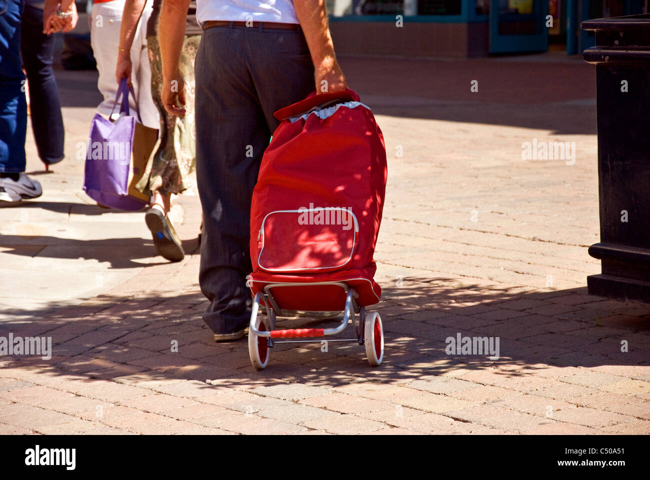 Pulling shopping trolley hi-res stock photography and images - Alamy