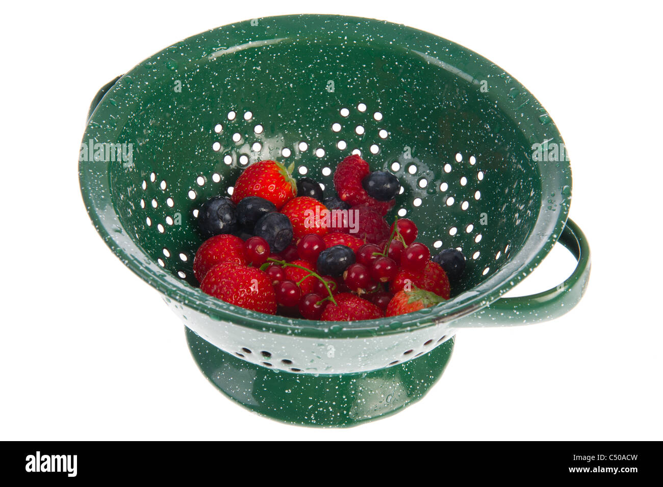 Washing fresh fruit in green colander isolated over white Stock Photo ...