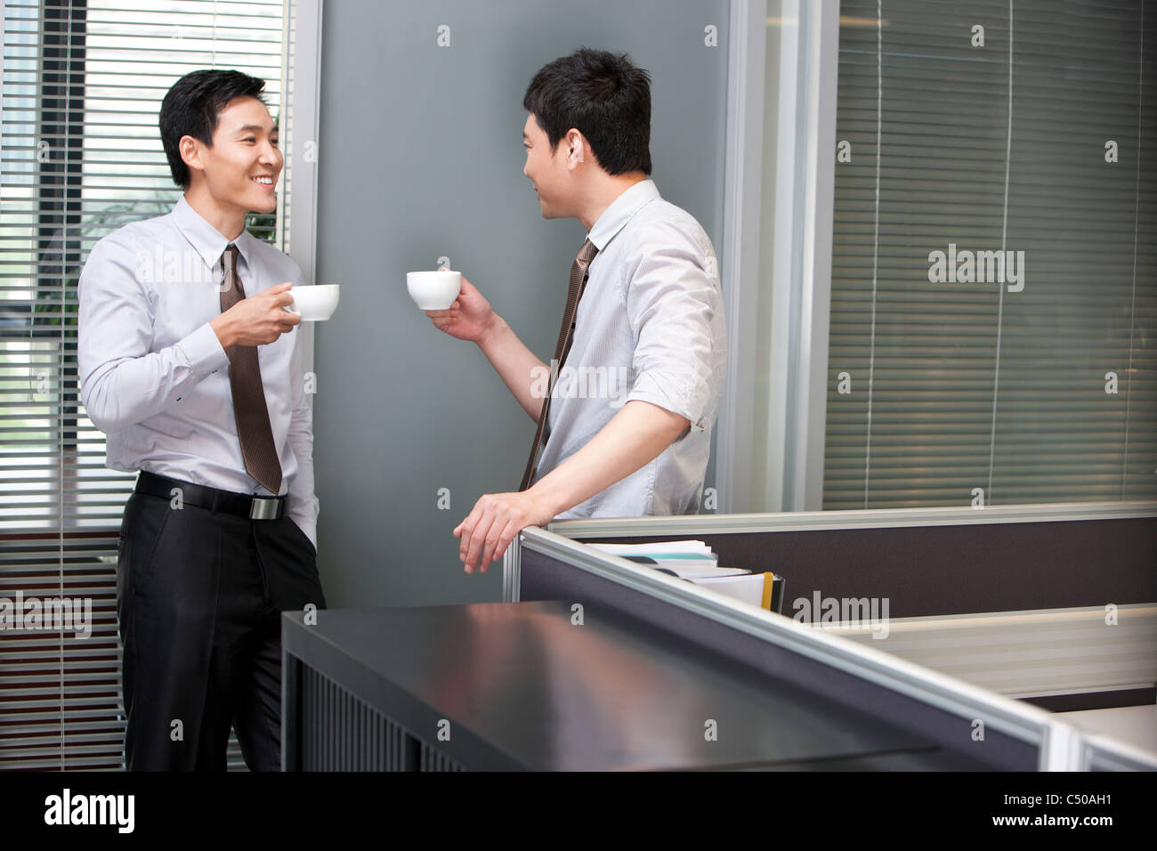 Two Young Businessmen Taking a Coffee Break Stock Photo - Alamy