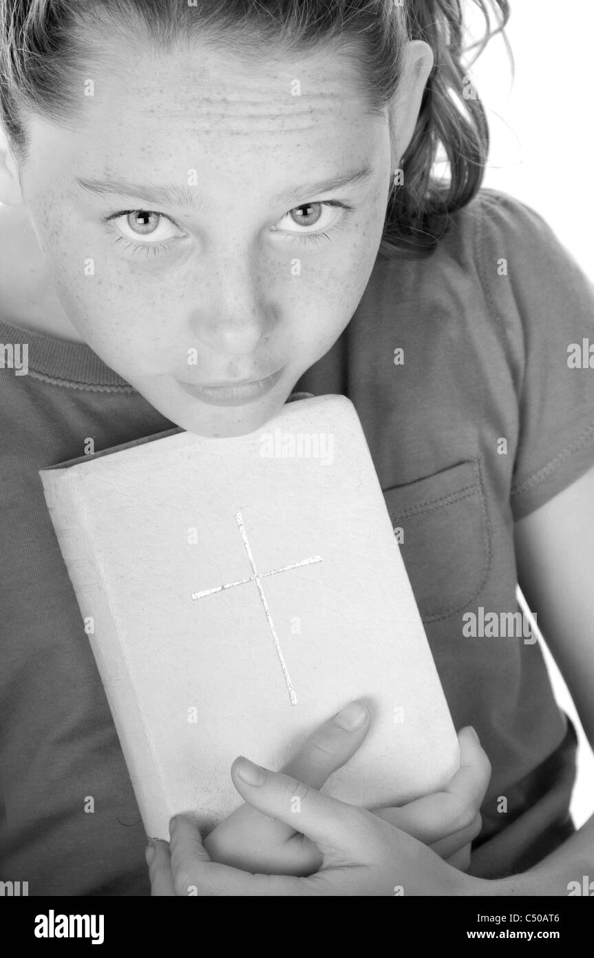 Young girl holding Bible Stock Photo - Alamy