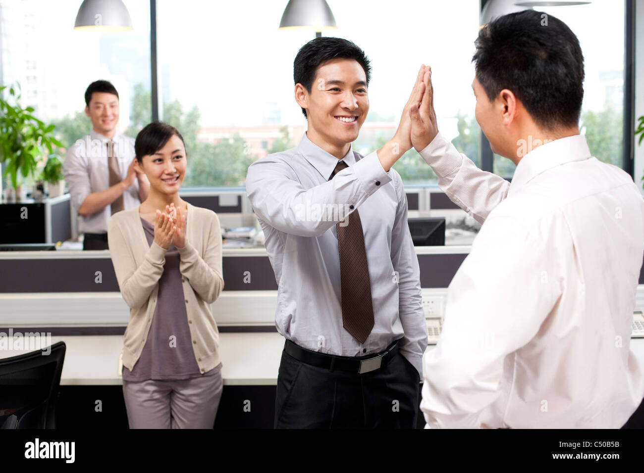 Office workers celebrating success Stock Photo - Alamy