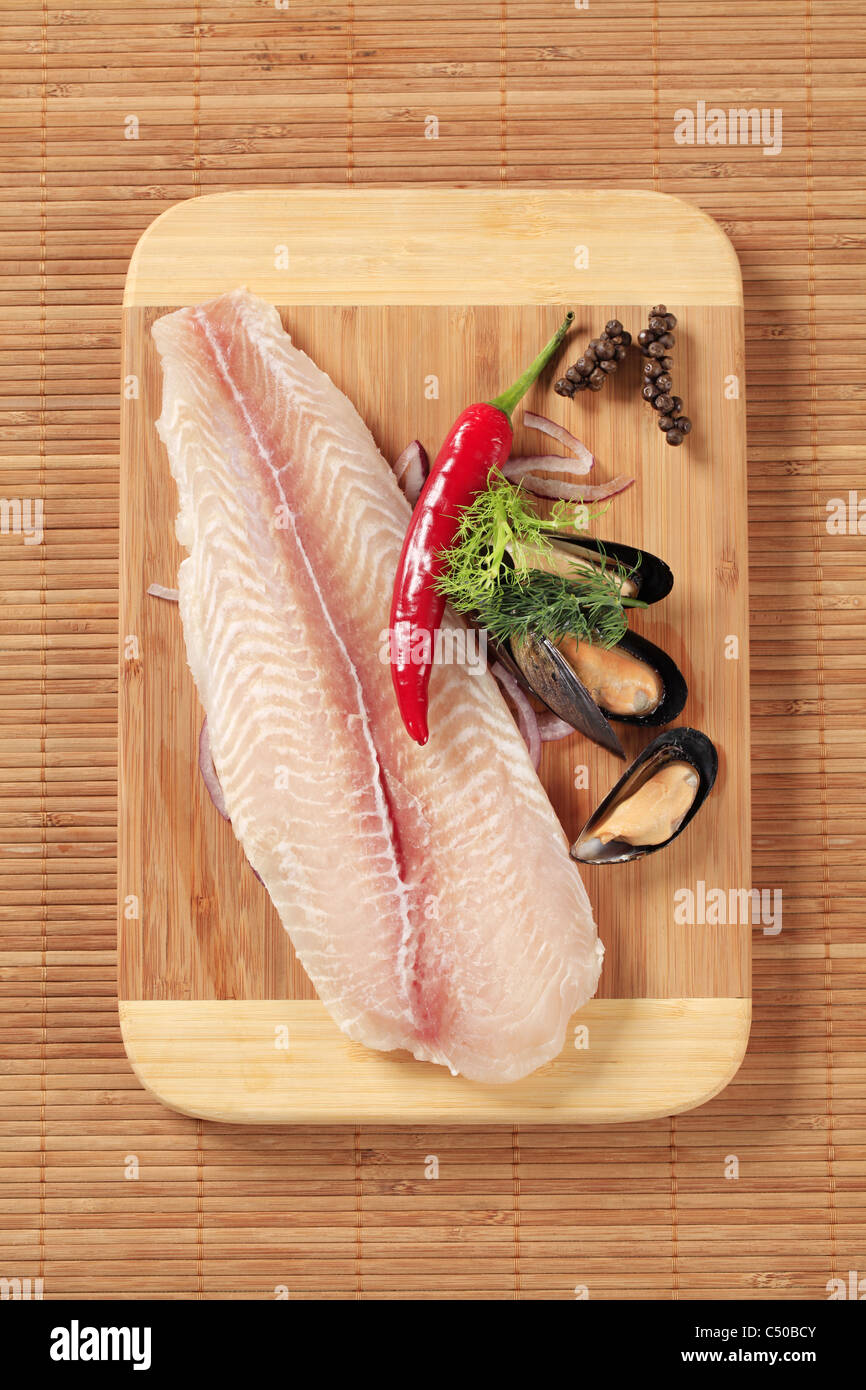 Fresh fish fillet and mussels on a cutting board Stock Photo - Alamy
