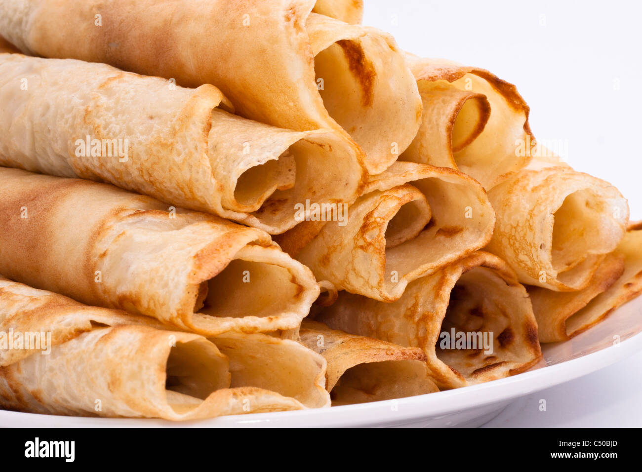 Detail of rolled crepes on white background Stock Photo - Alamy