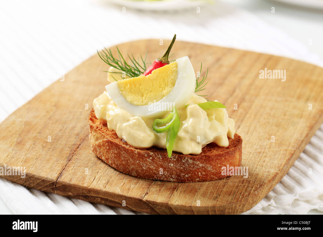 Slice of toasted bread and egg spread Stock Photo - Alamy