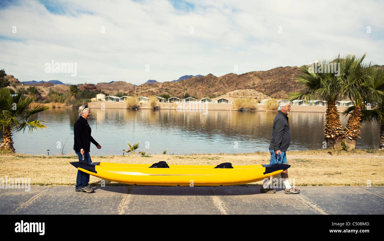 Two men carrying kayak outdoors hi-res stock photography and images - Alamy