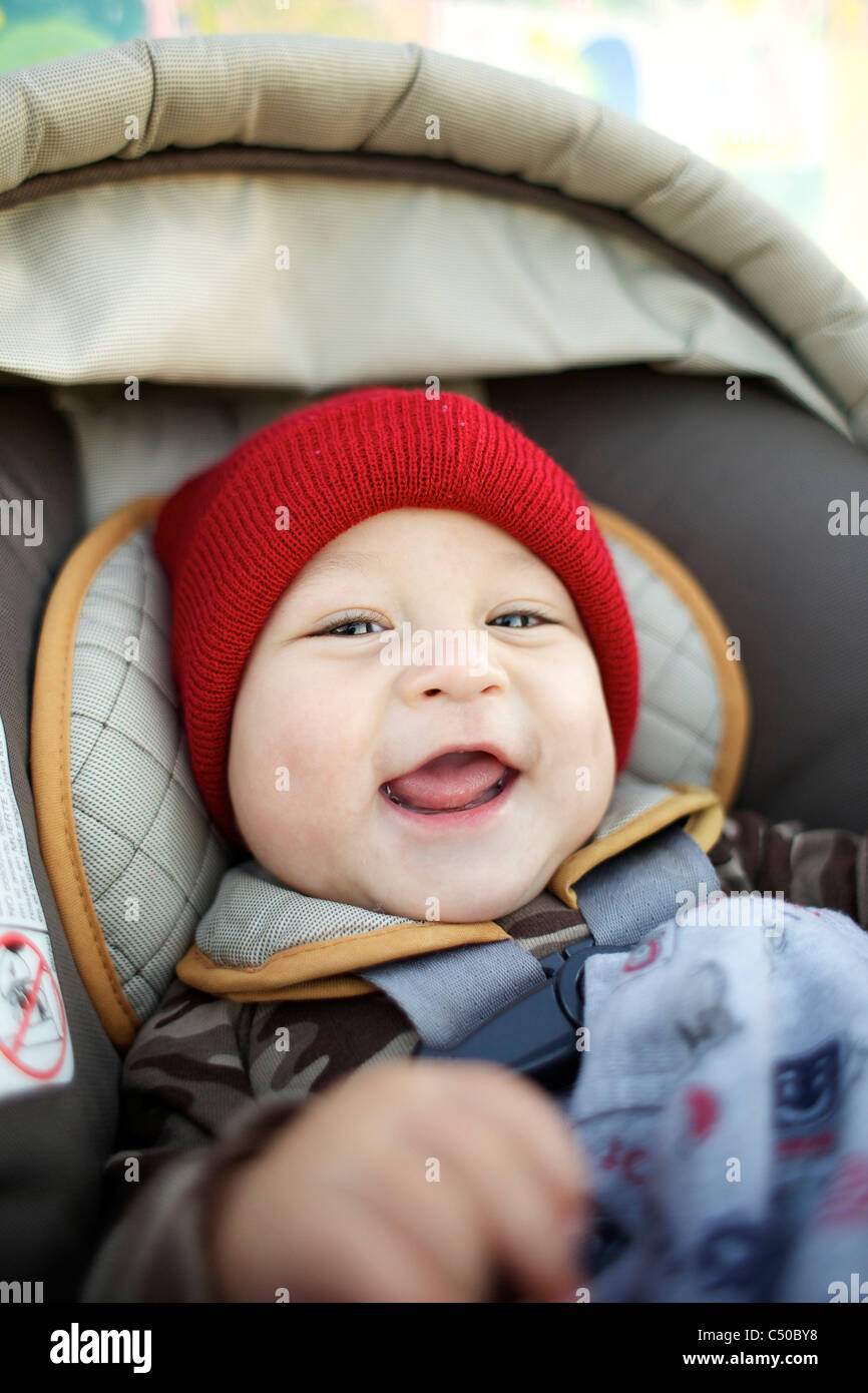Grinning mixed race baby in car seat Stock Photo - Alamy