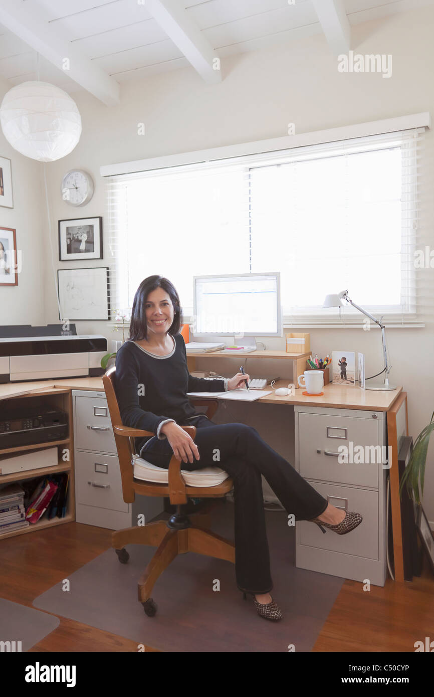 Hispanic woman working in home office Stock Photo - Alamy