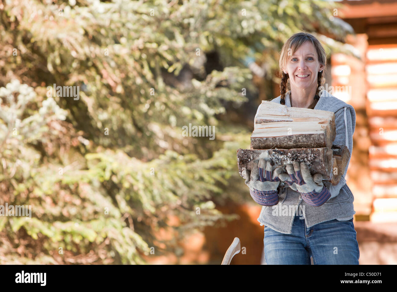 Woman carrying firewood hi-res stock photography and images - Alamy