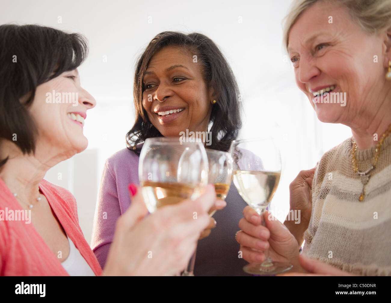 Friends drinking white wine together Stock Photo - Alamy
