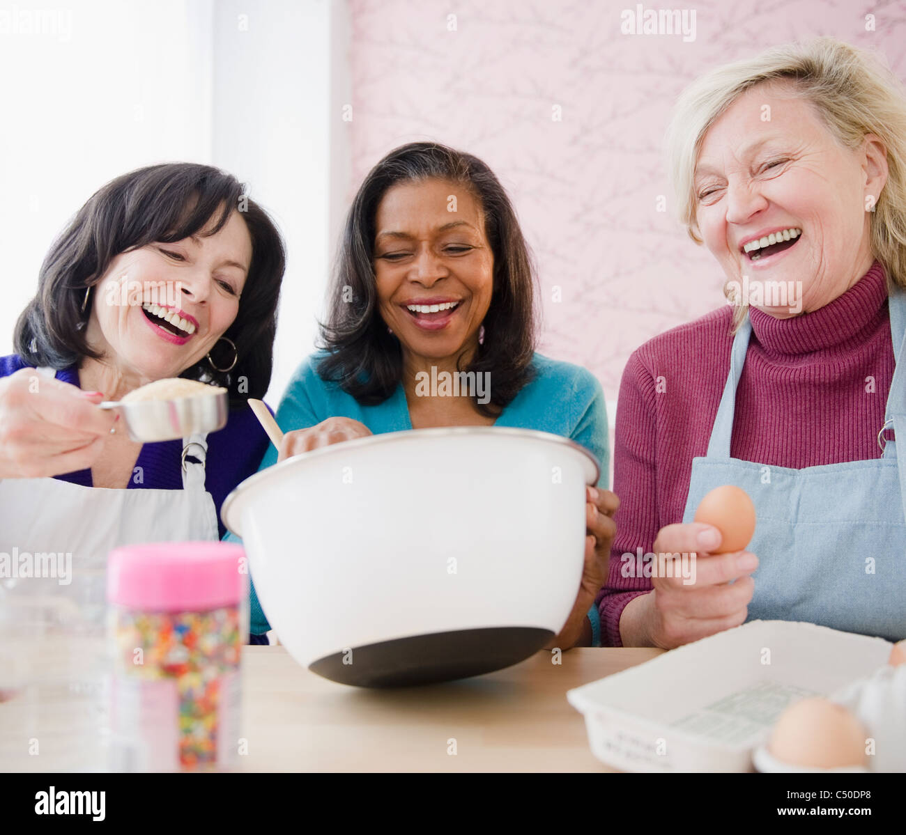 Friends baking together Stock Photo - Alamy