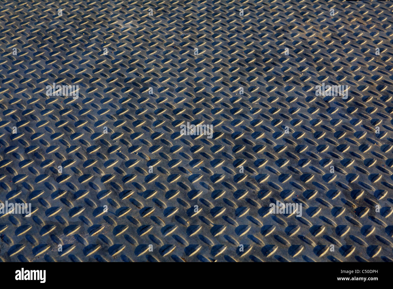 Blue hued steel treaded grating walk way Stock Photo - Alamy