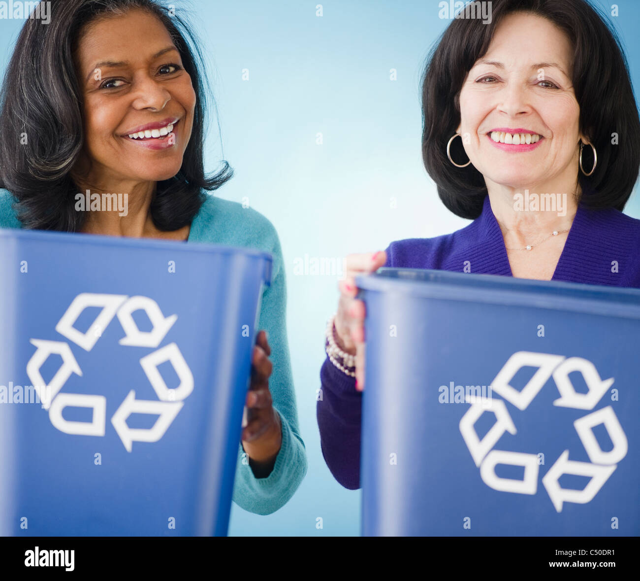 Friends carrying recycling bins Stock Photo - Alamy