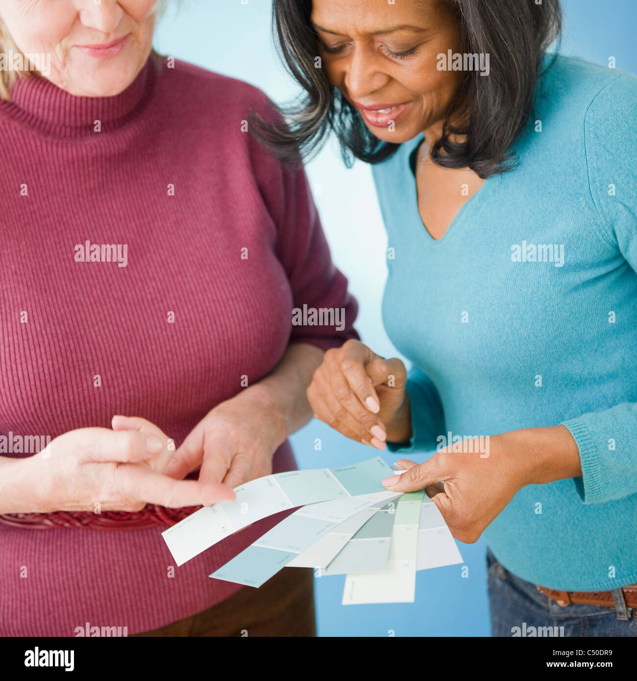Friends looking at color swatches together Stock Photo - Alamy
