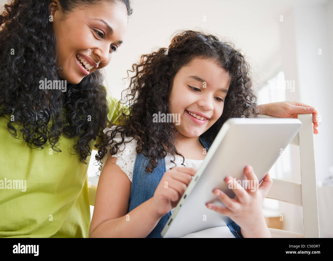 Happy latin family using tablet hi-res stock photography and images - Alamy