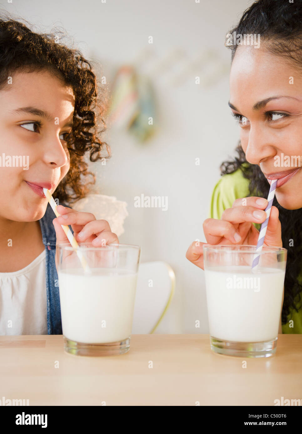 Daughter drinking milk together hi-res stock photography and images - Alamy