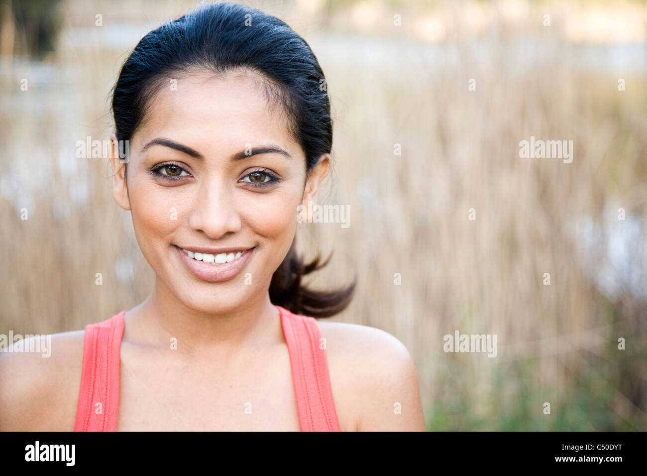Smiling Indian woman outdoors Stock Photo - Alamy