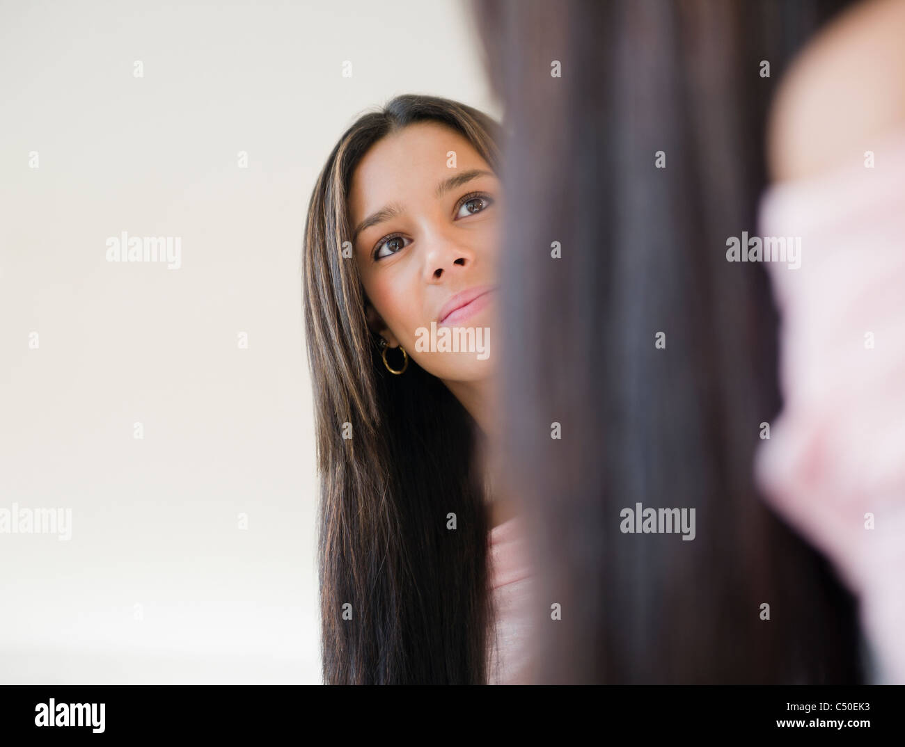 Hispanic teenager looking into mirror Stock Photo - Alamy