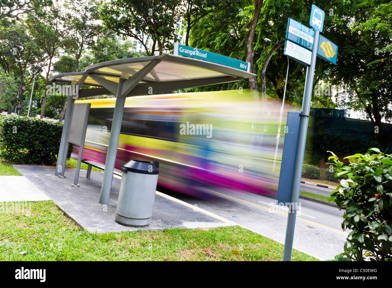 Motion blurred Bus leaving bus stop on Grange Road Singapore Stock ...