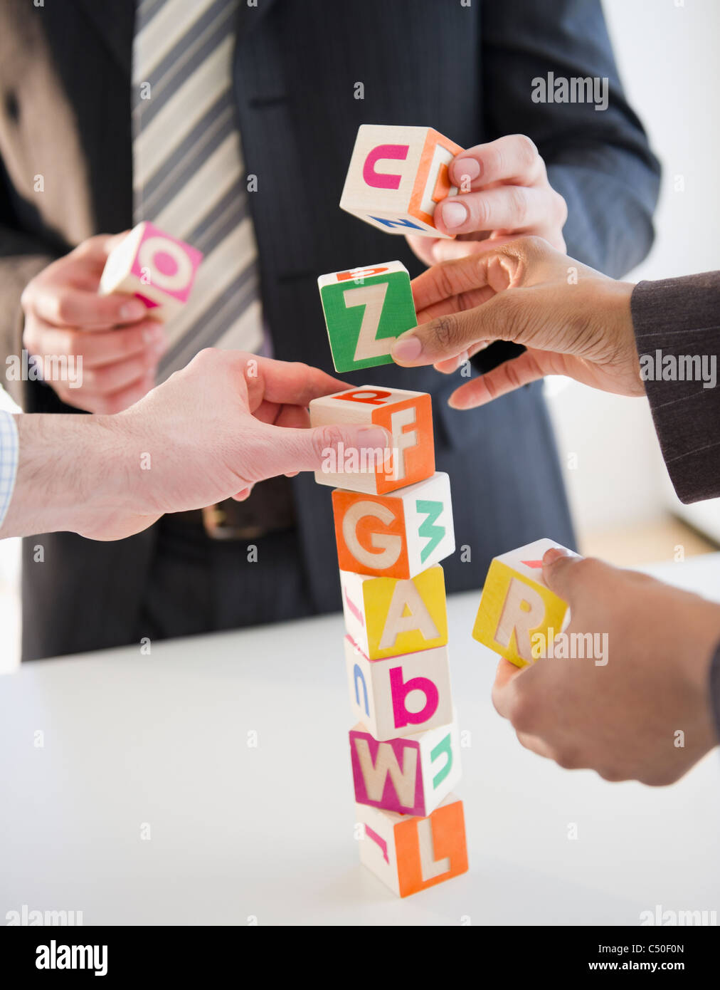 Business people stacking alphabet blocks Stock Photo - Alamy