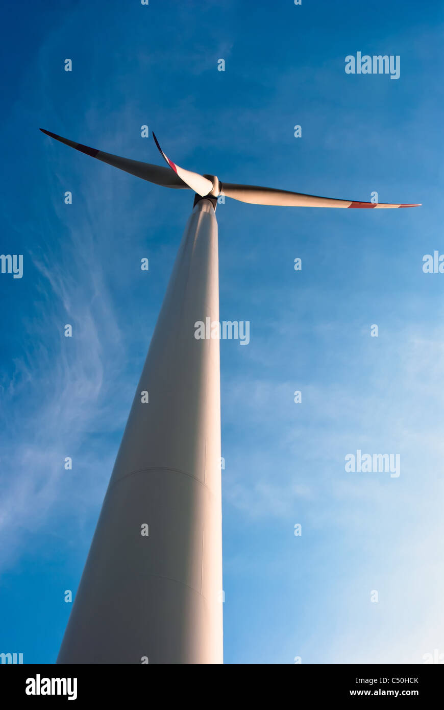 a big wind turbine stands in front of blue sky with clouds Stock Photo ...