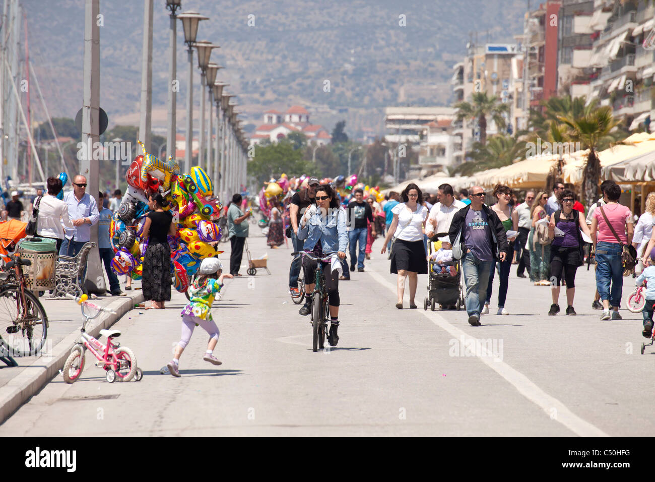 the busy waterfront promenade of the coastal port city Volos in ...