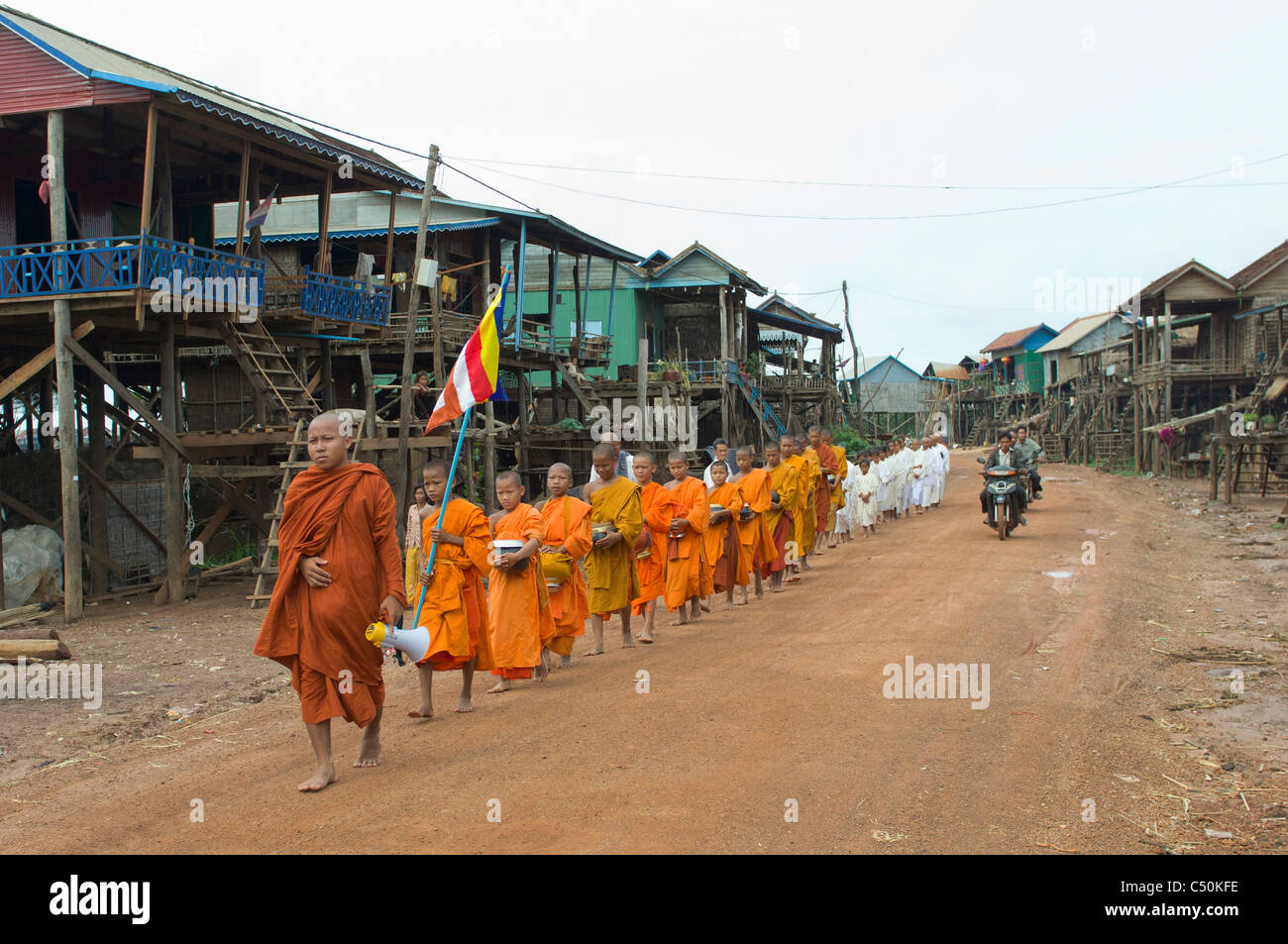 Buddhist monks and nuns on their morning alms round, Kompong Klang, on ...